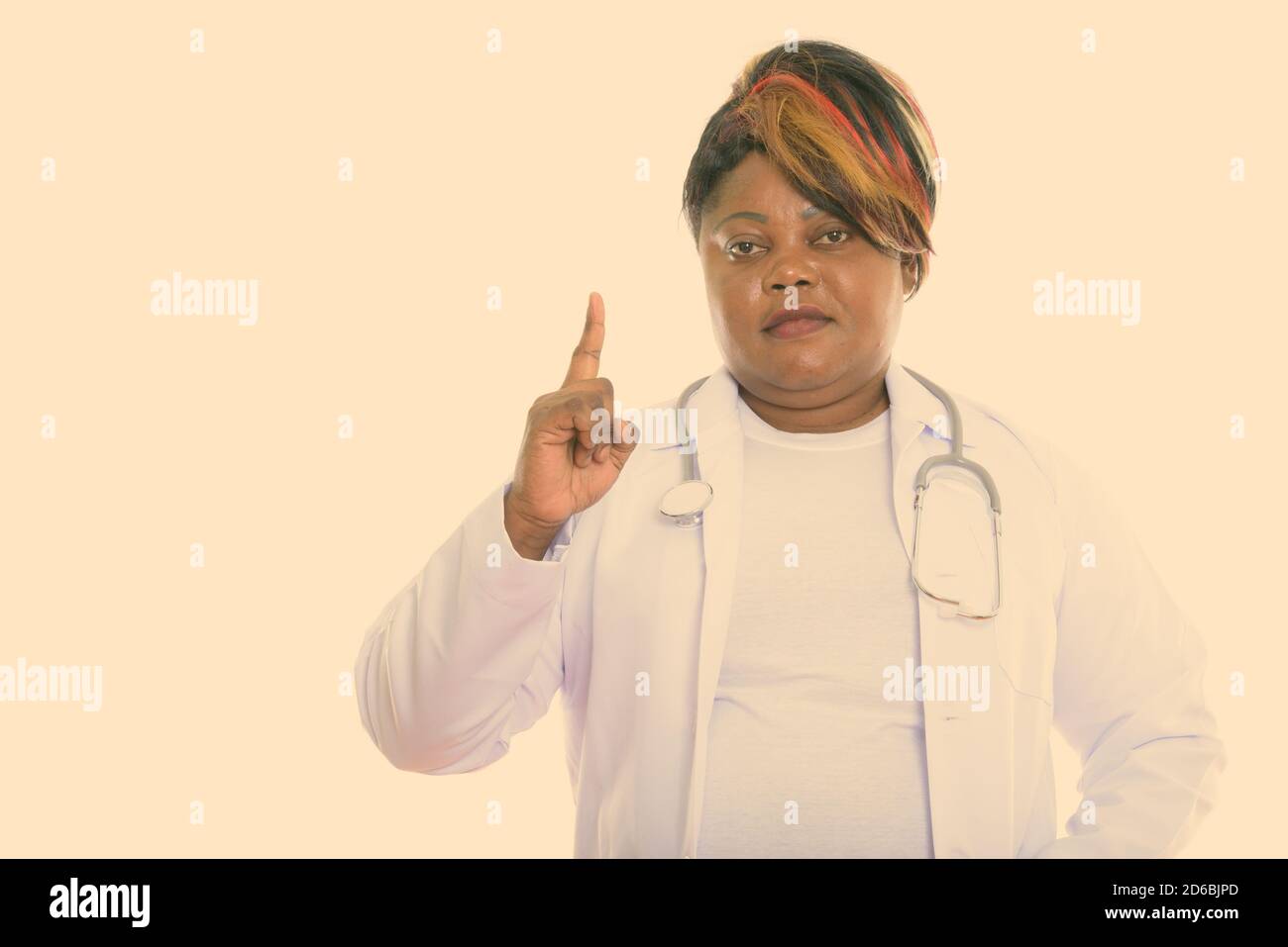 Studio shot of fat black African woman doctor pointing finger up Stock ...