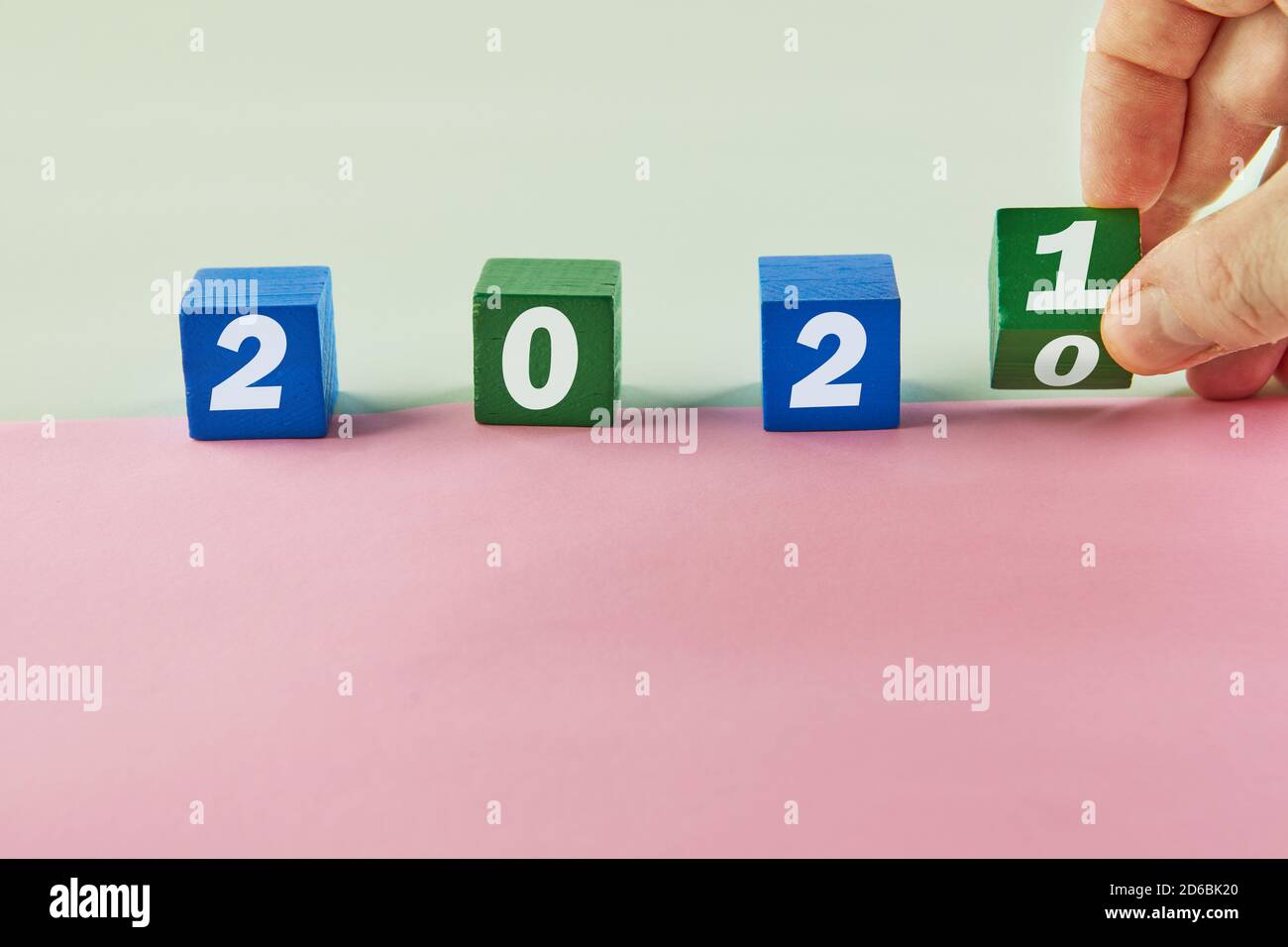 Hand turns a dice and changes the year 2020 to 2021 Stock Photo - Alamy
