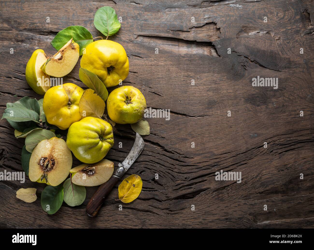 Ripe golden yellow quince fruits on wood. Organic fruits on old table ...