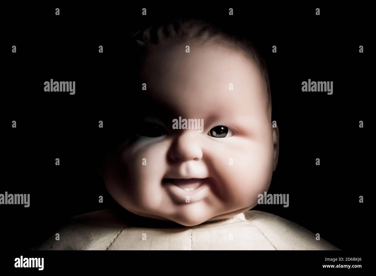 Creepy doll face. It seems like character of horror movie. Angry baby ...