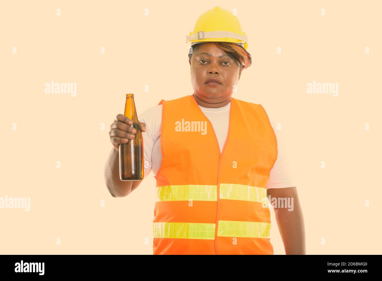Studio shot of fat black African woman construction worker holding ...
