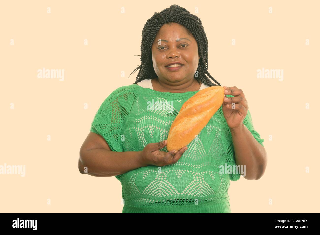 Studio shot of happy fat black African woman smiling while holding ...