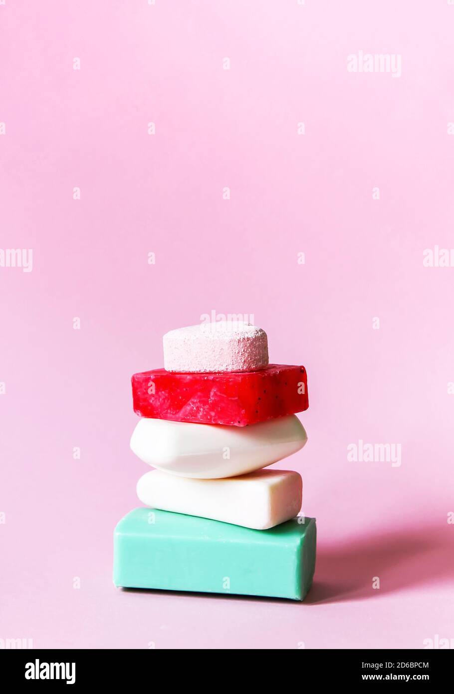 Different homemade coloful soap on soft pink background Stock Photo - Alamy