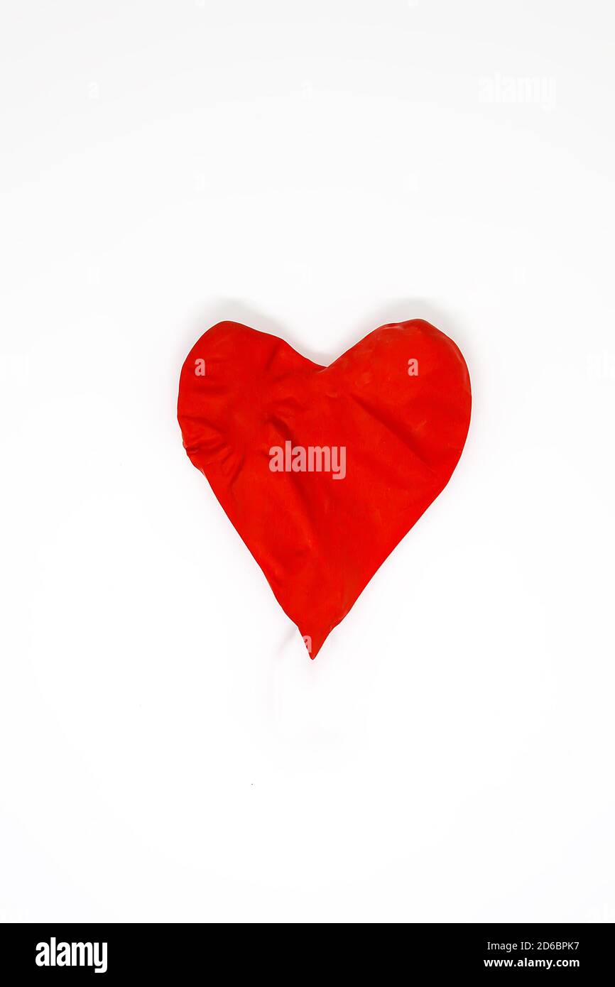 Red heart deflated balloon on white background Stock Photo - Alamy