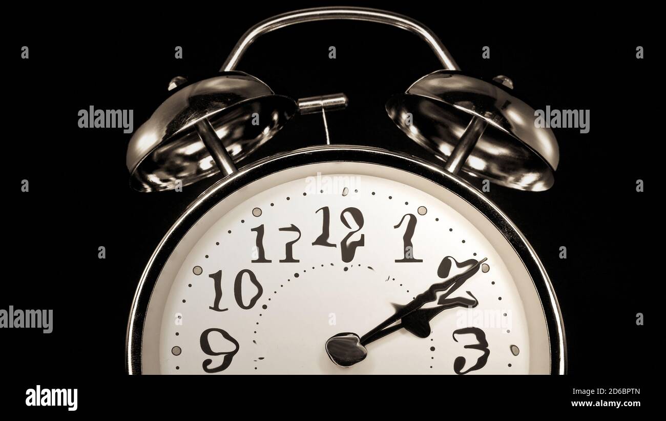 retro alarm clock distorted and melting isolated on a black background ...