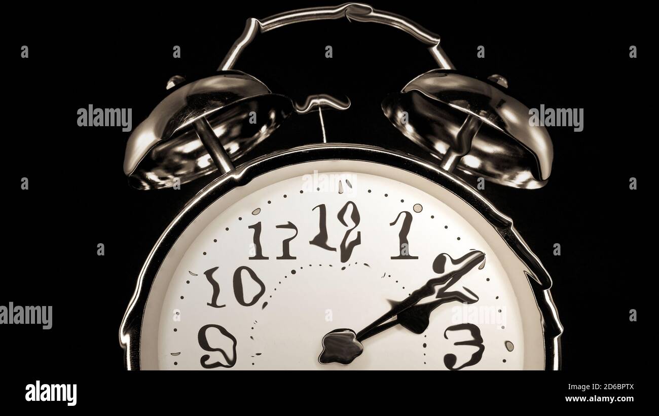 retro alarm clock distorted and melting isolated on a black background ...