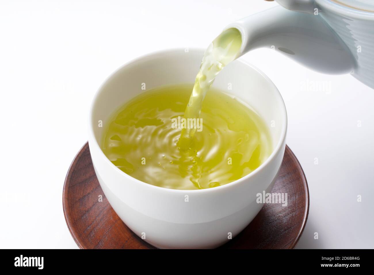 Pouring green tea into a teacup. Japanese green tea image Stock Photo ...