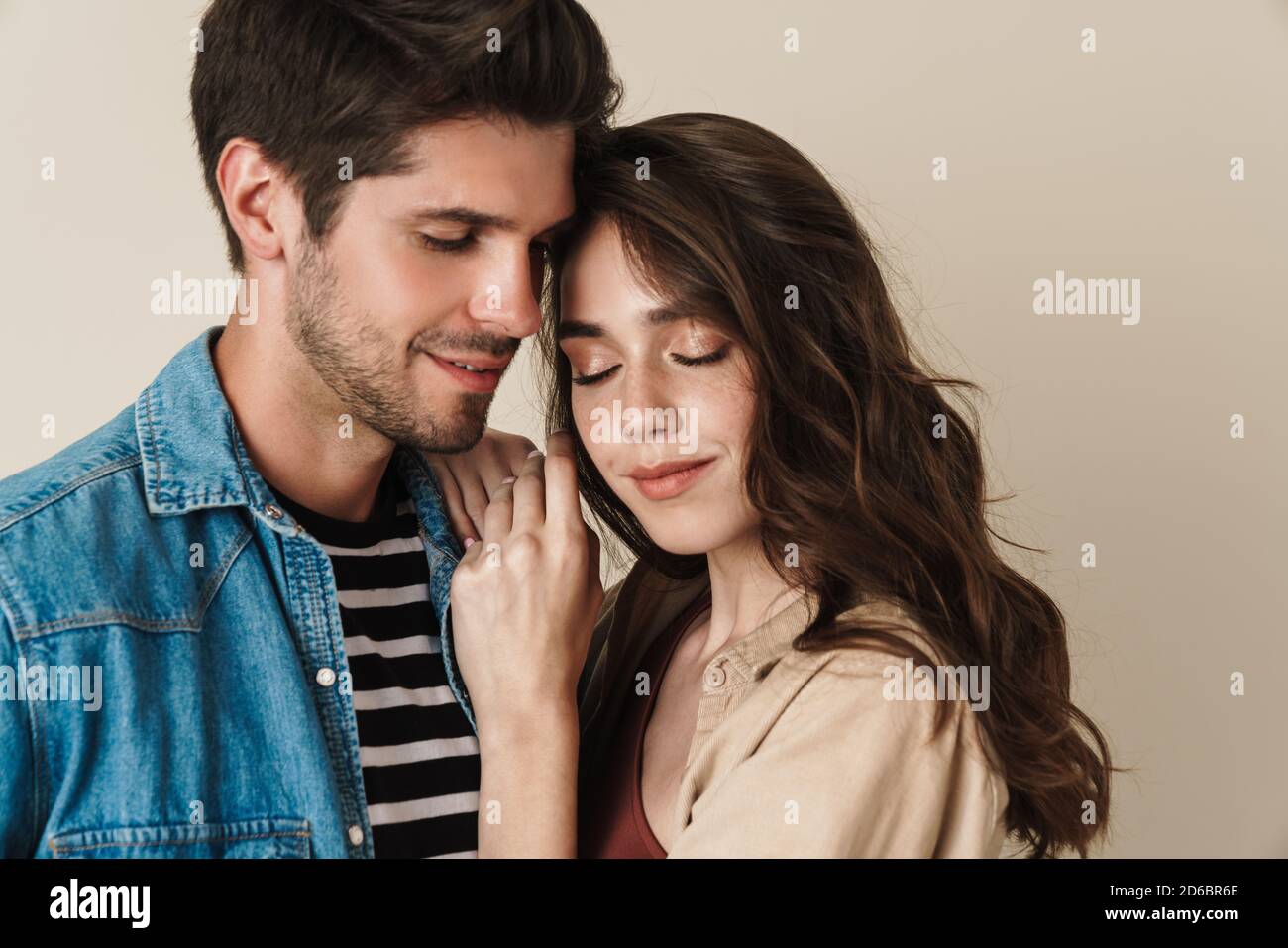 Image of romantic beautiful couple hugging and posing with eyes closed ...