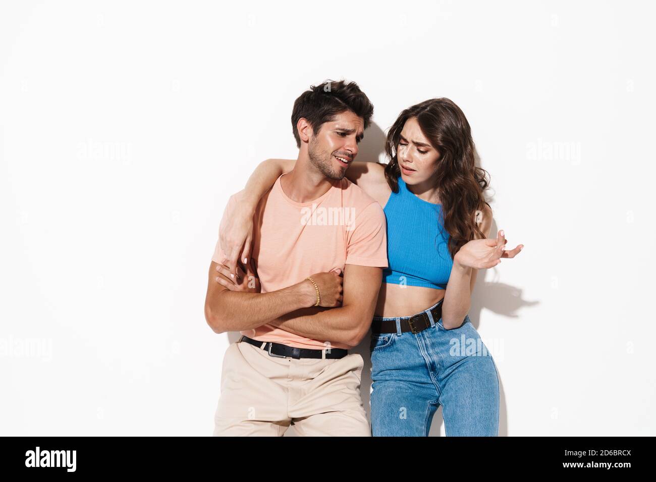 Image of attractive young couple hugging and talking isolated over ...