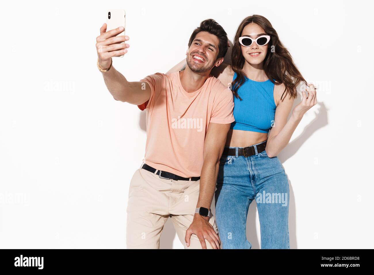 Image of attractive happy couple smiling while selfie on smartphone ...
