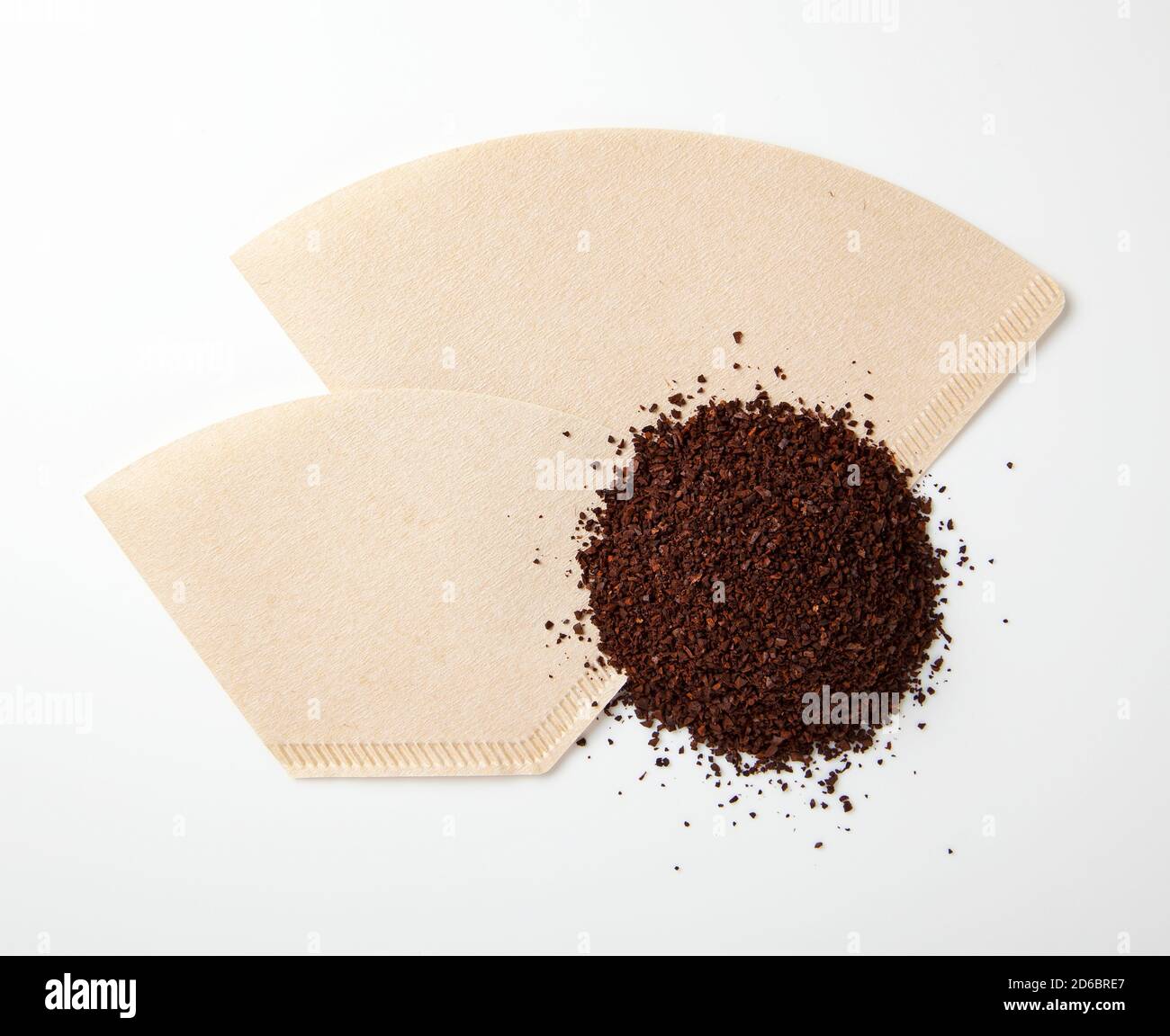 Aerial view of coffee filter and coffee powder on a white background ...