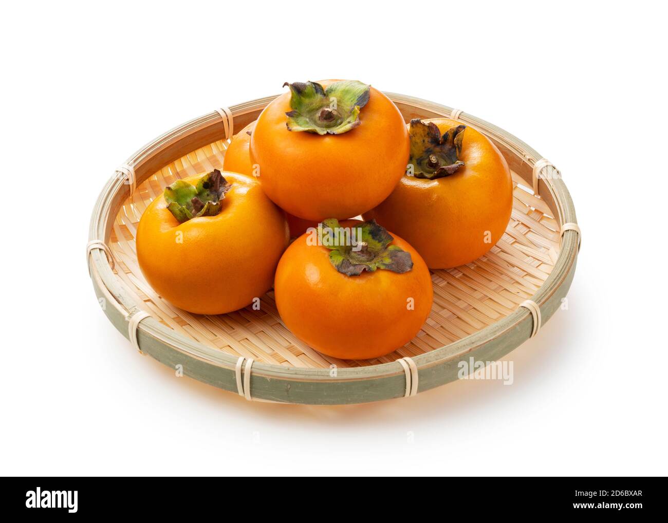 Japanese persimmon in a colander on a white background Stock Photo - Alamy