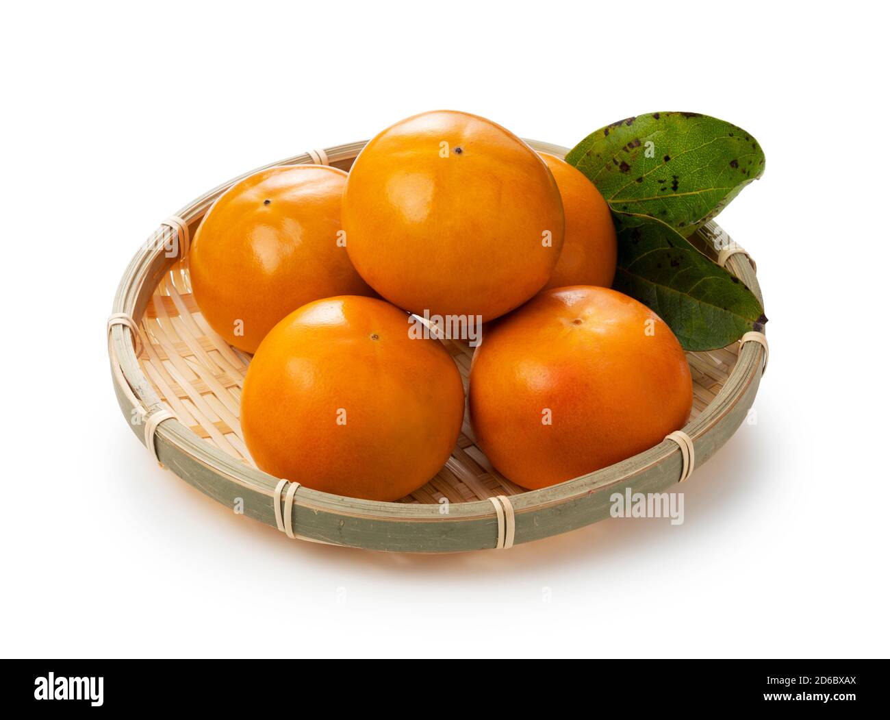 Japanese persimmon in a colander on a white background Stock Photo - Alamy