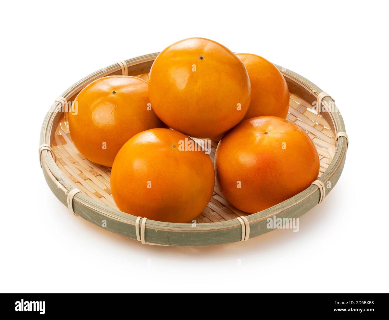 Japanese persimmon in a colander on a white background Stock Photo - Alamy