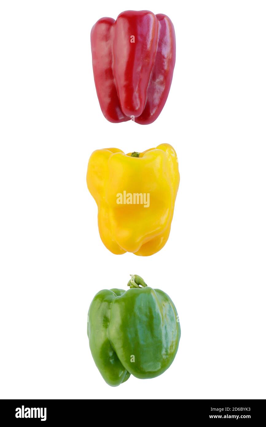 Red, yellow and green peppers against white background. Traffic light ...