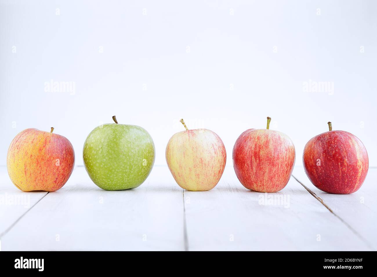 Row of different types of apples against white background Stock Photo ...