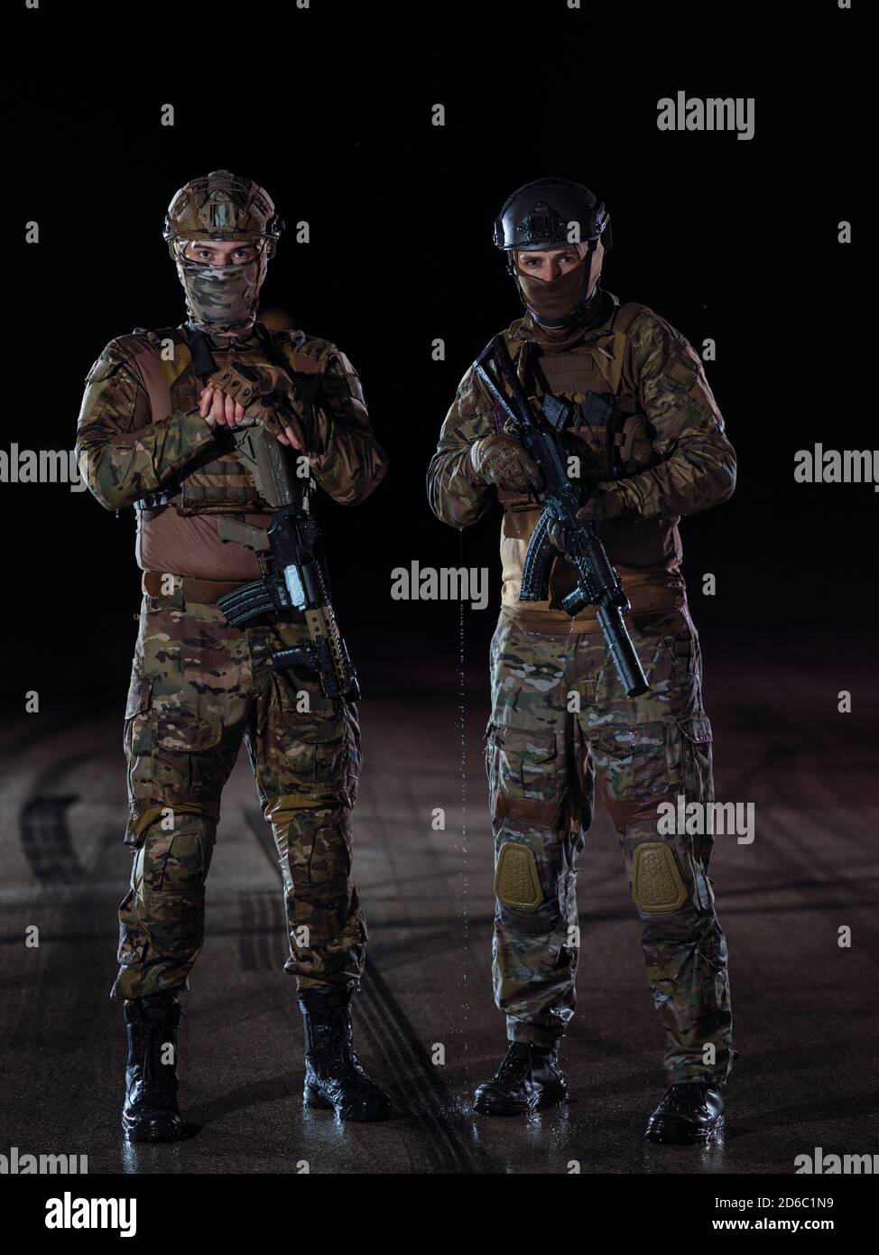 Two heavily armed special forces soldiers in full protective military ...