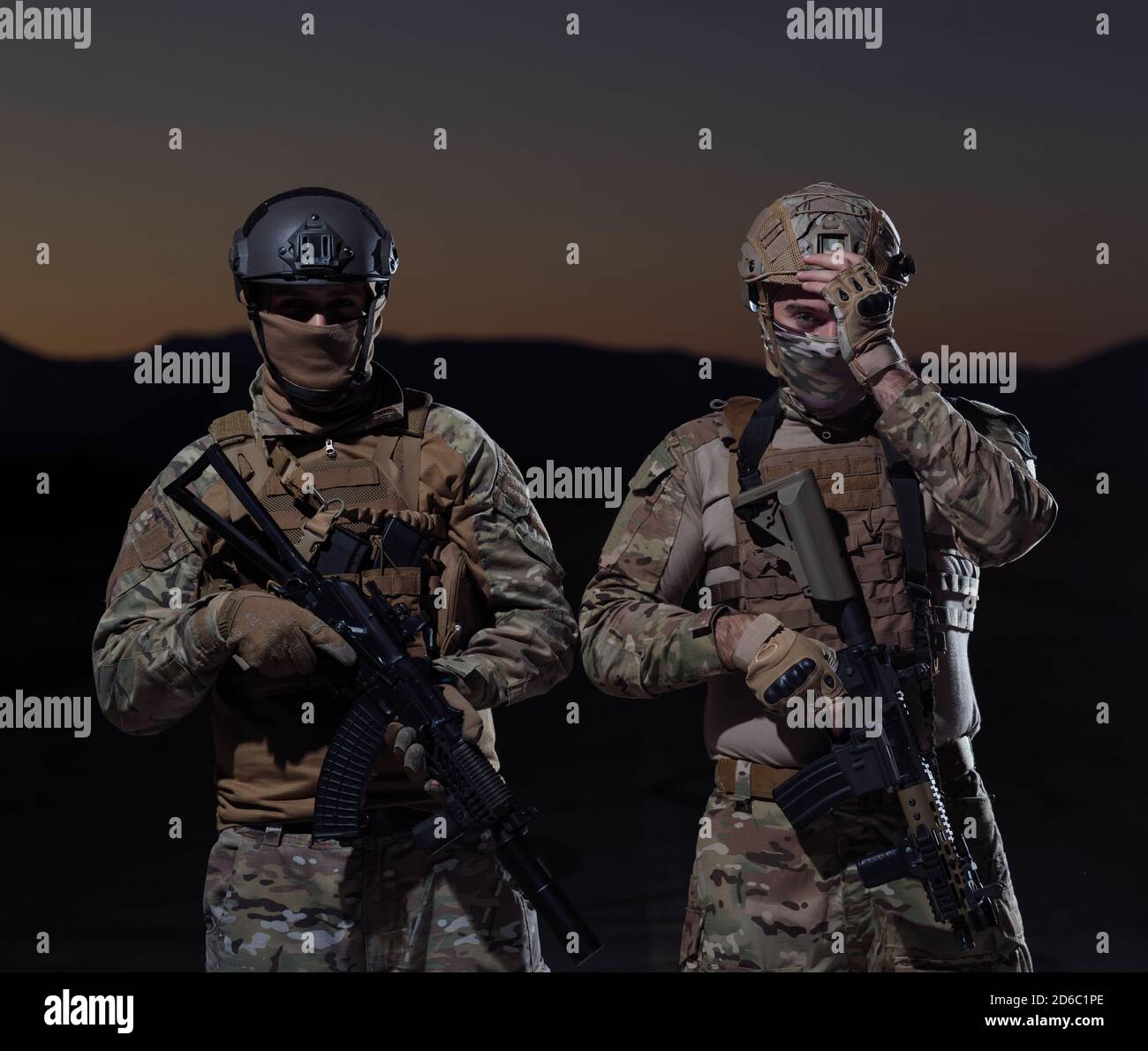 Two heavily armed special forces soldiers in full protective military ...