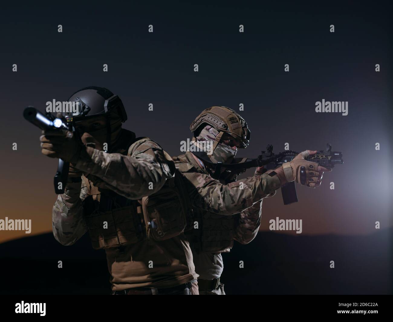 Two heavily armed special forces soldiers in full protective military ...
