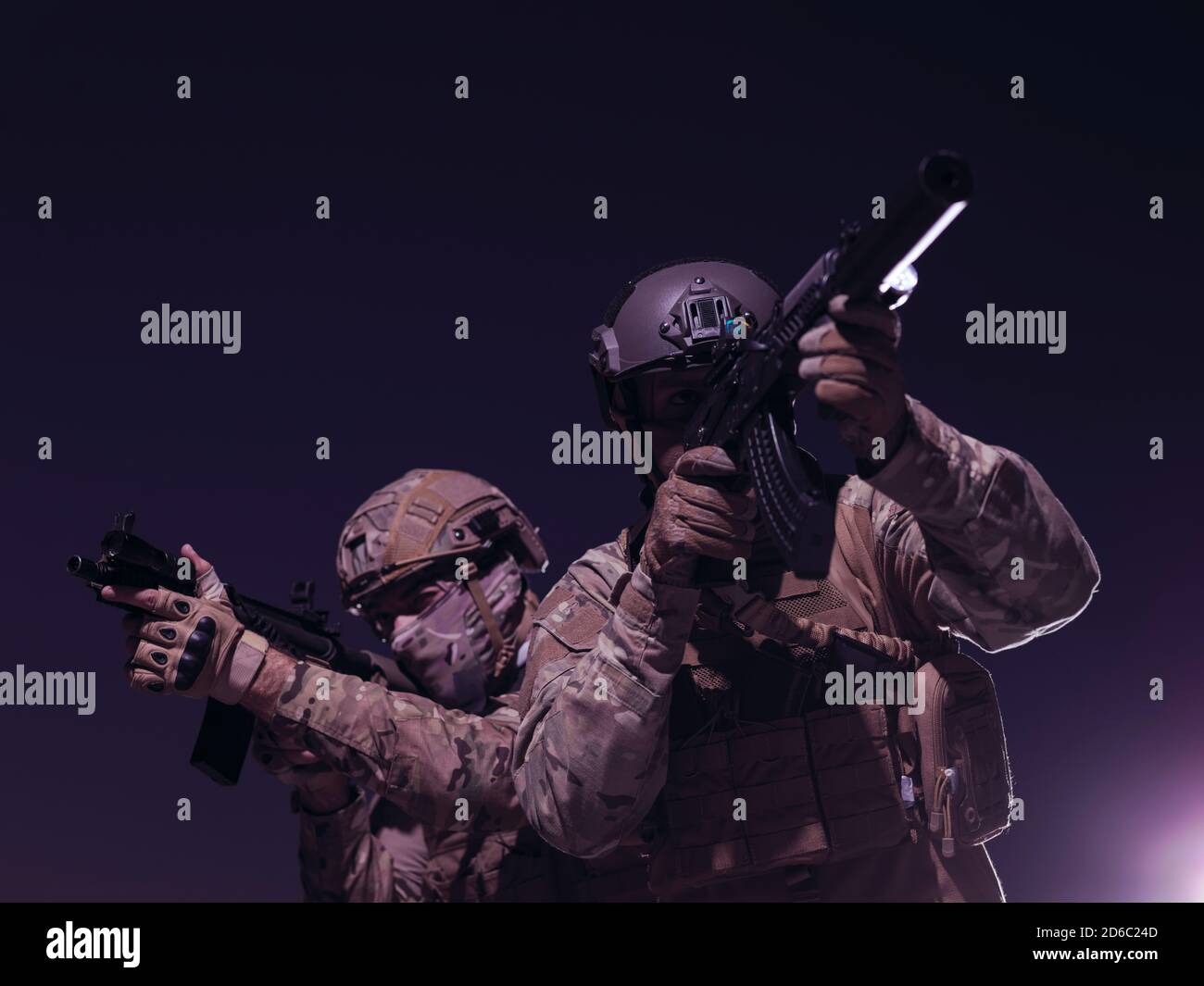 Two heavily armed special forces soldiers in full protective military ...