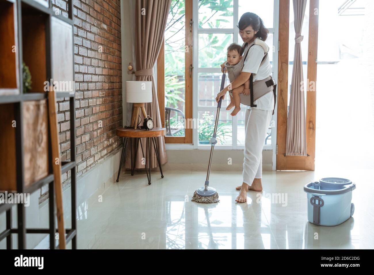 mother and baby girl clean room and having fun Stock Photo - Alamy
