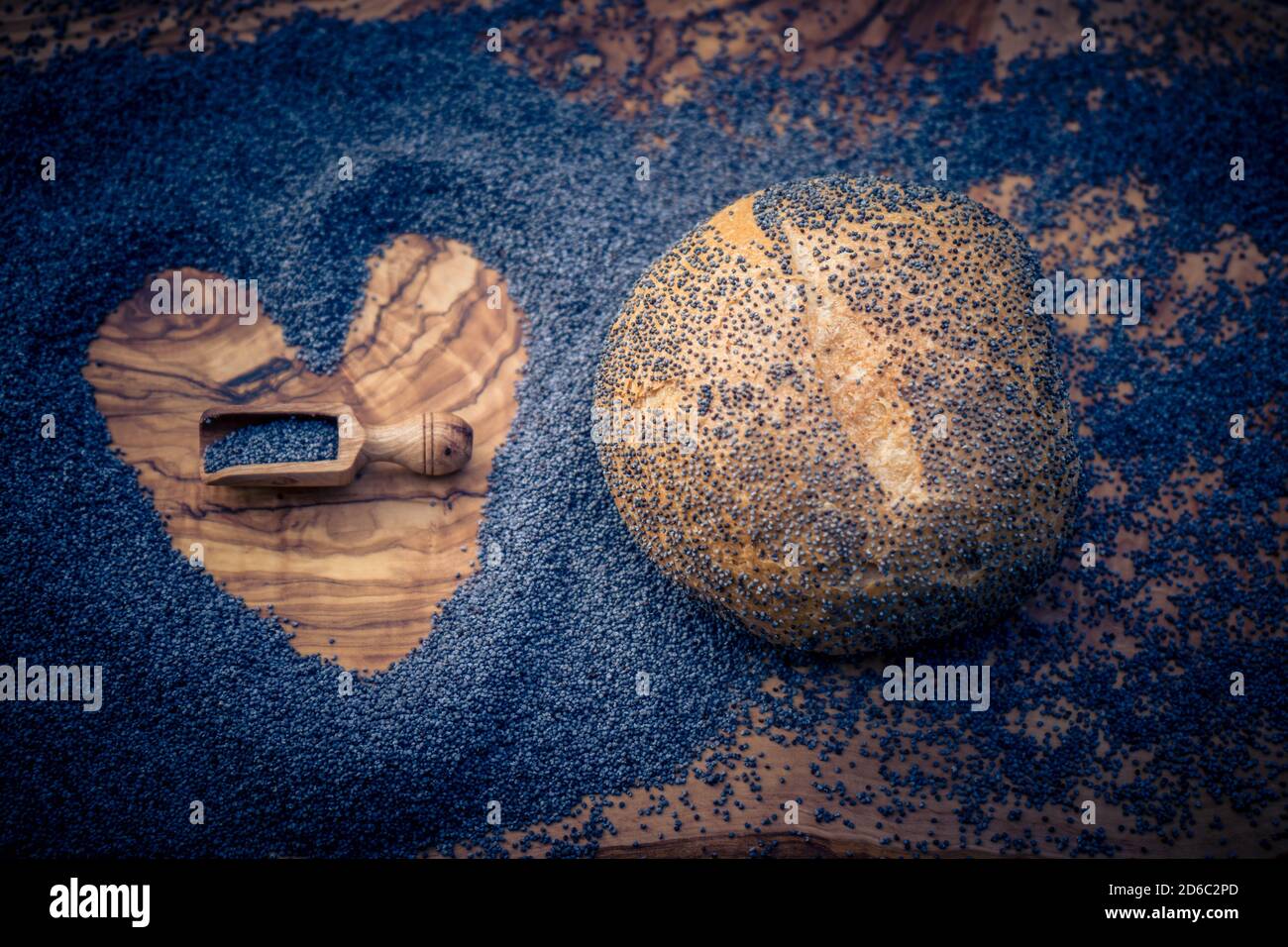 Blue poppy seeds on olive wood Stock Photo - Alamy