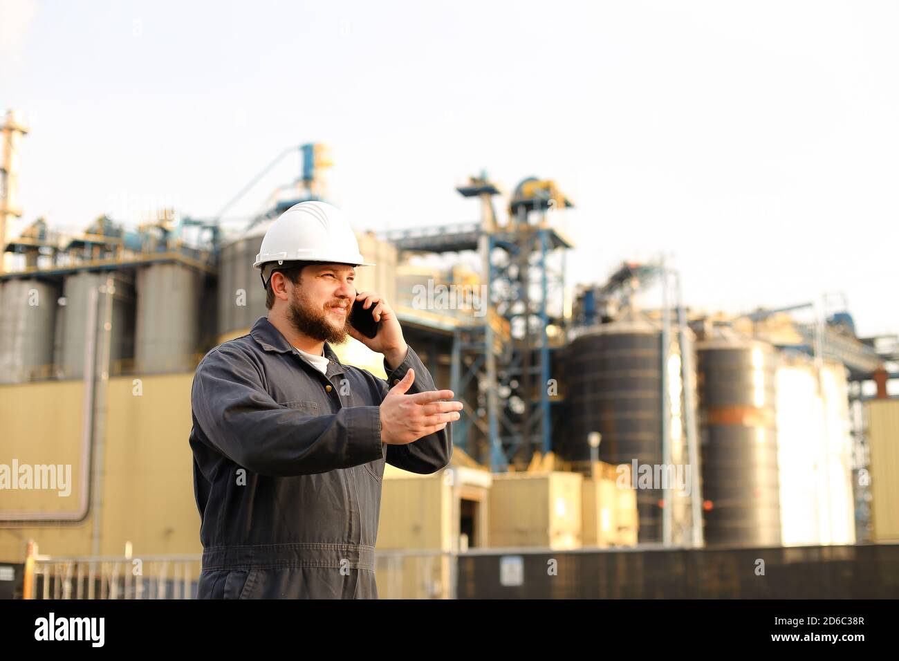 Industrial engineer talking by VHF walkie talkie near factory outside ...