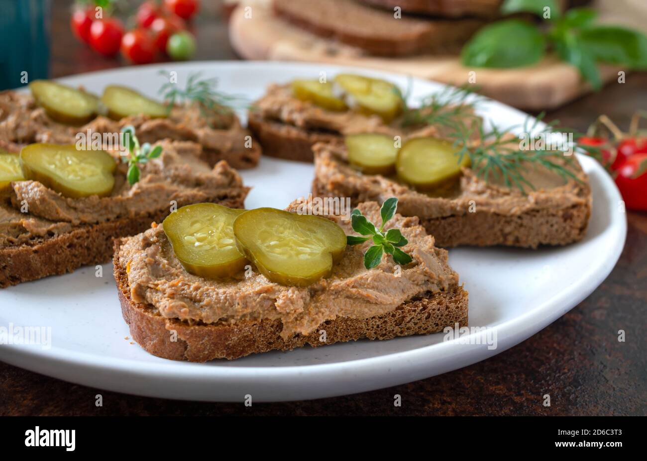Canapes with chicken liver pate and pickled cucumbers on rye bread ...