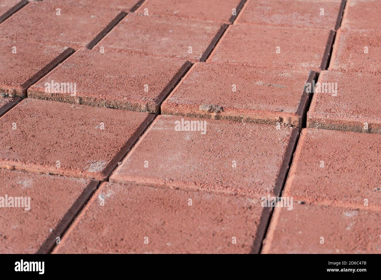 Red bricks laid out in a row for masonry, contruction and development ...