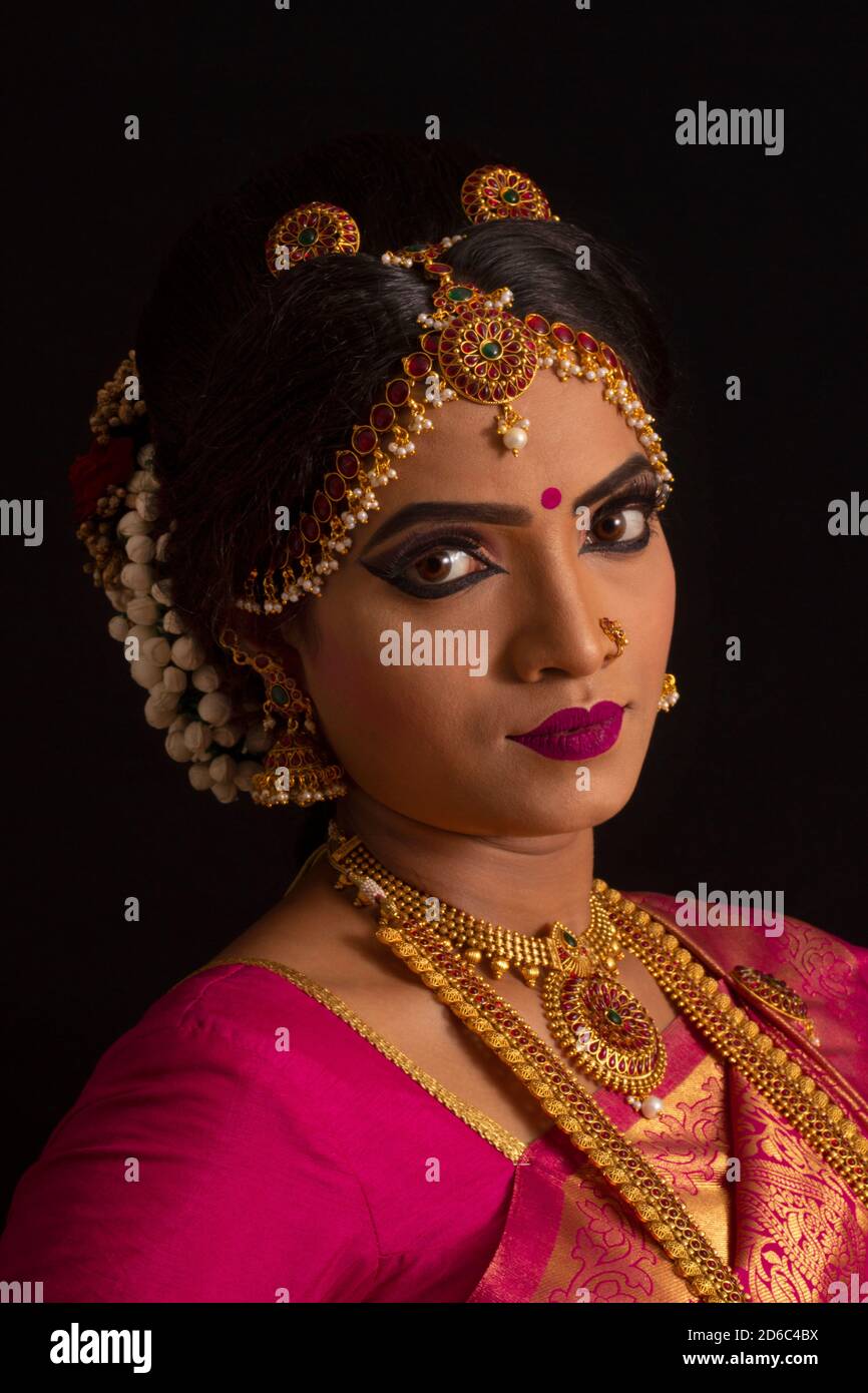 Young South Indian model in bridal red sari with golden jewelry set ...
