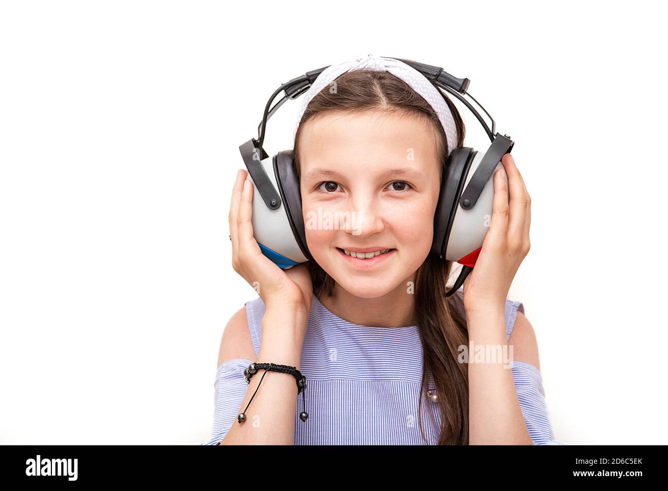 Hearing test. Positive girl in headphones during a hearing test ...