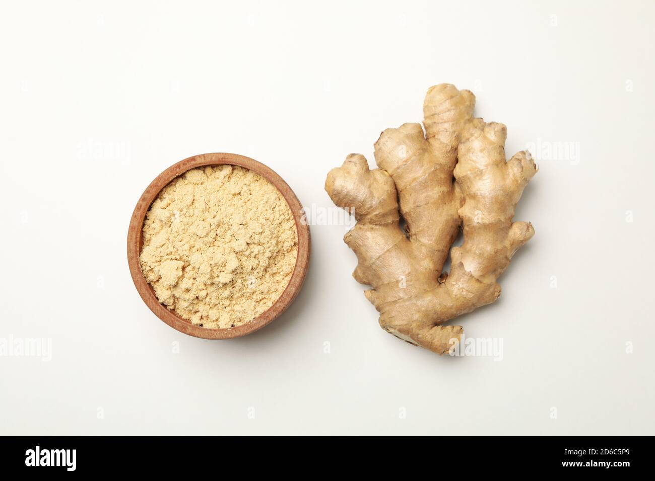 Ginger and bowl with ginger powder on white background Stock Photo - Alamy