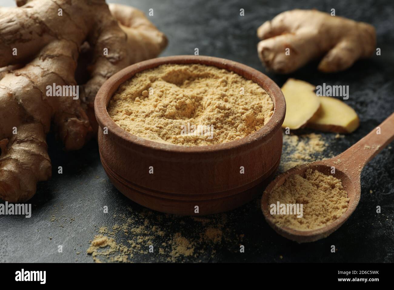 Ginger and bowl with ginger powder on black smoky background Stock ...