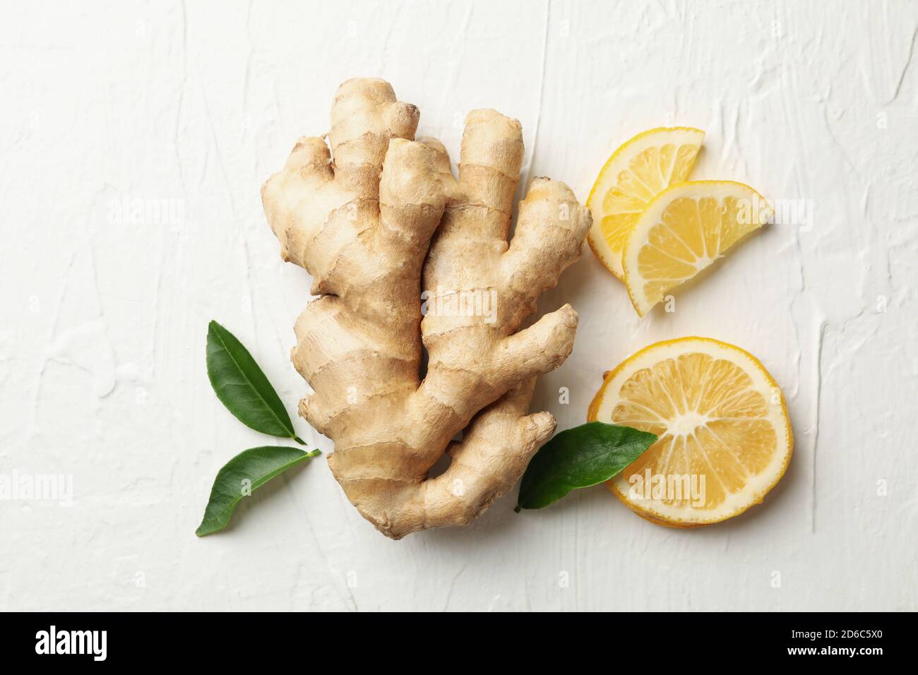 Fresh raw ginger and lemon on white background Stock Photo - Alamy