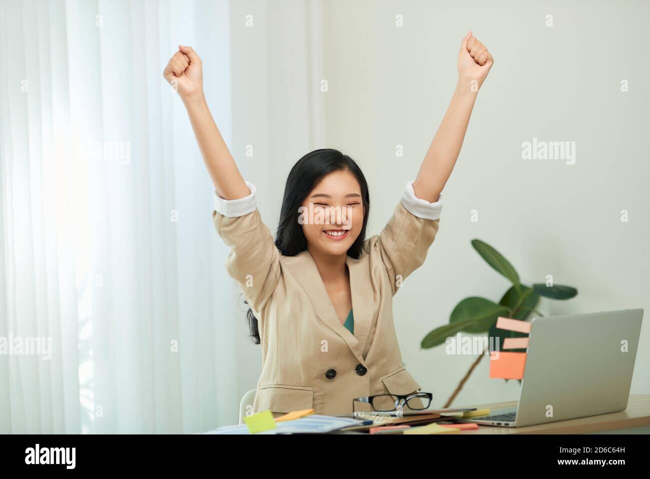 Young girl student winner celebrate victory triumph sit at home desk ...