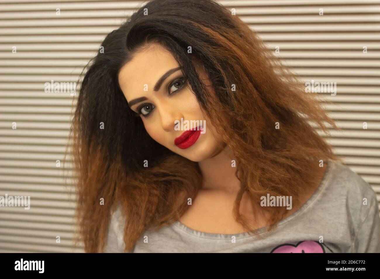 Young girl with disheveled hair looking at camera. Face close-up Stock ...