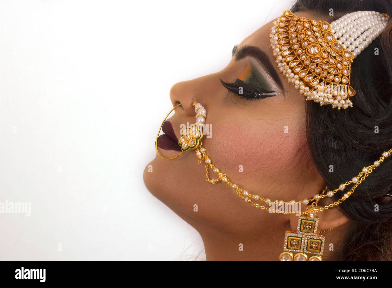 Side face closeup profile of Indian model in bridal wear with heavy ...