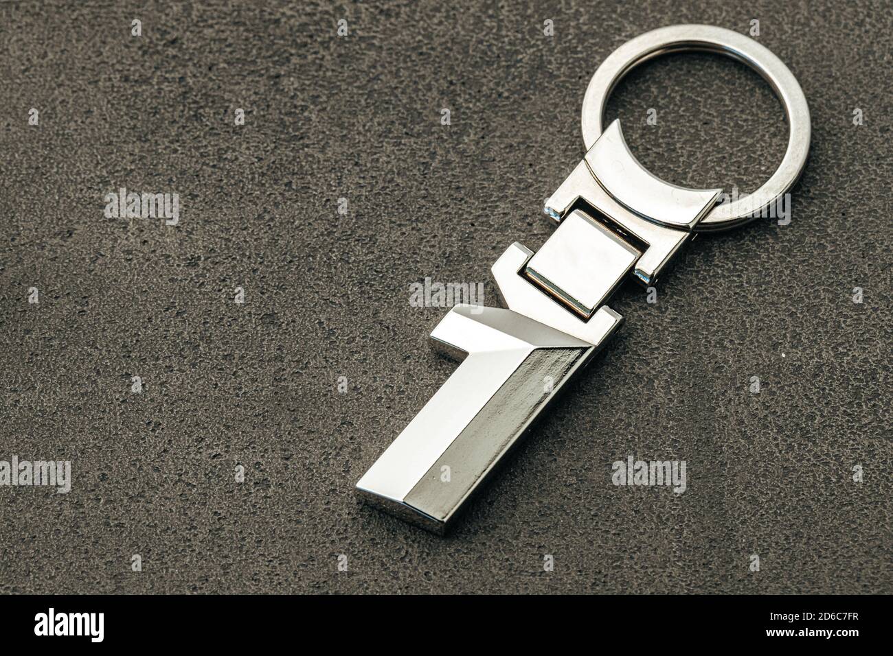 Metal number One car key on dark concrete background Stock Photo - Alamy