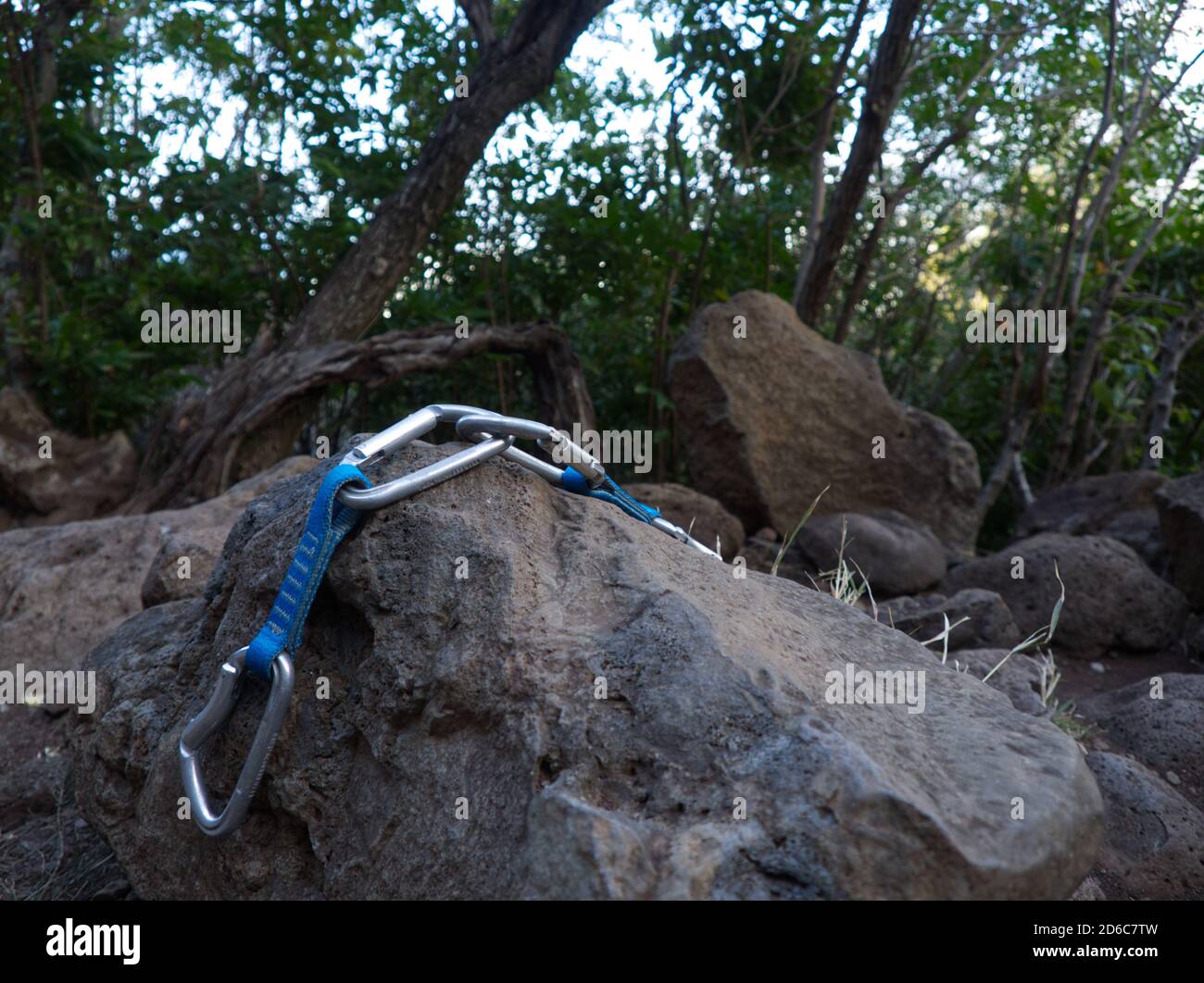 Focus on quickdraws put down on a rock with blurred front and back ...
