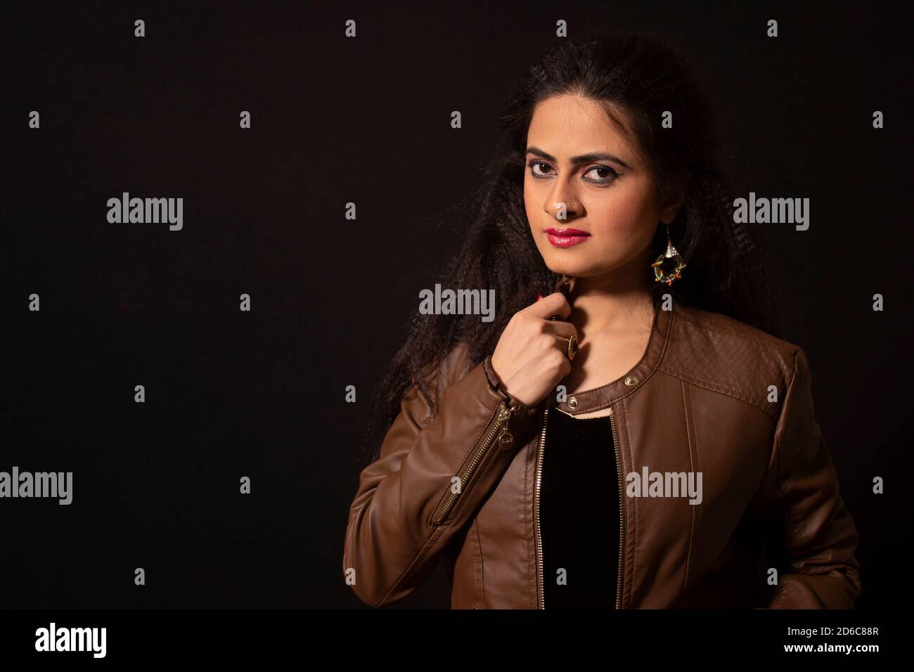 Young Indian female model looking at camera. Black background Stock ...