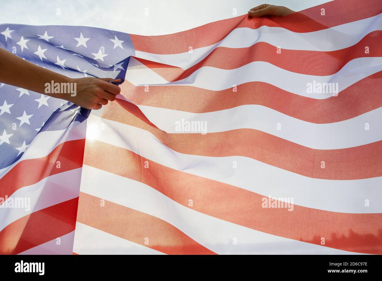 Two human hands holding USA national flag. Celebration of International ...