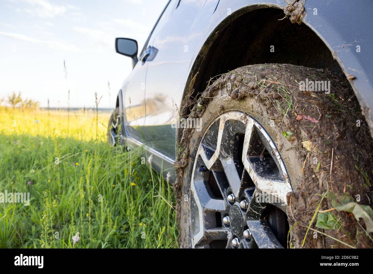 Close up of dirty off road car wheels with dirty tires covered with ...