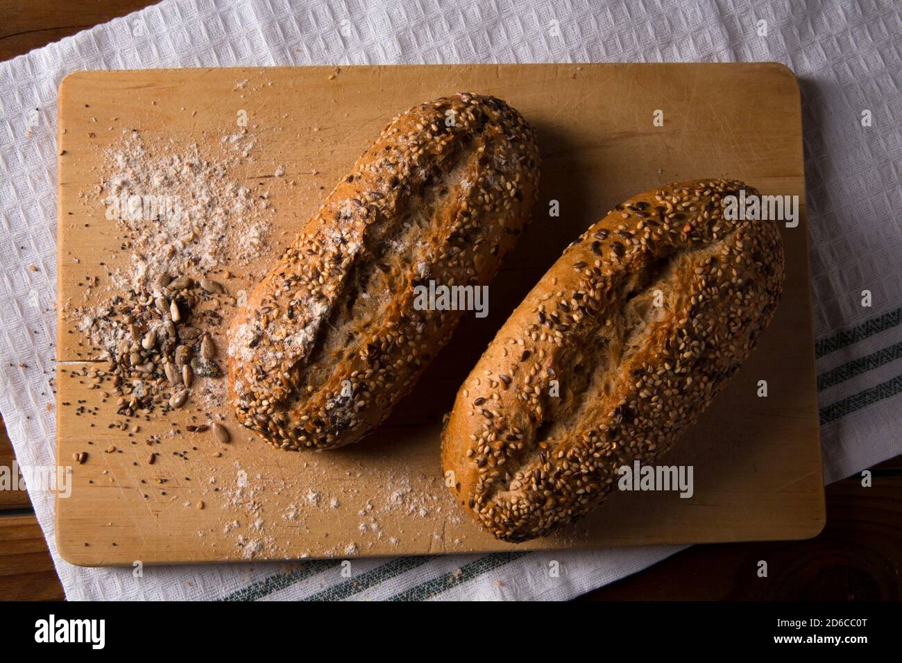 multigrain wholemeal bread with seeds on brown wooden table Stock Photo ...