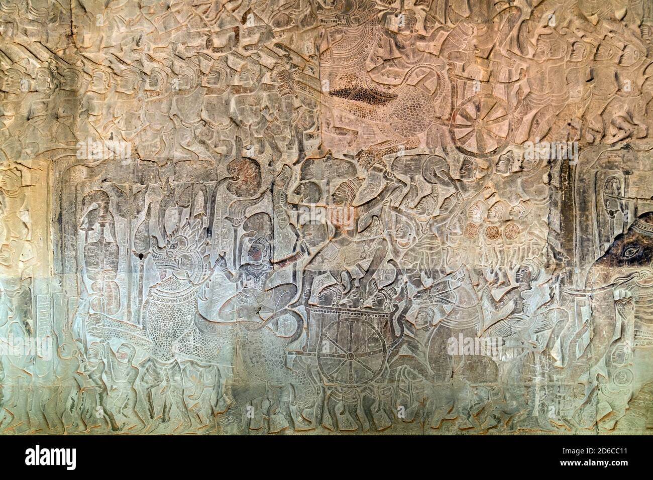 Khmer relief carving of gods fighting demons. Inner wall of the temple ...