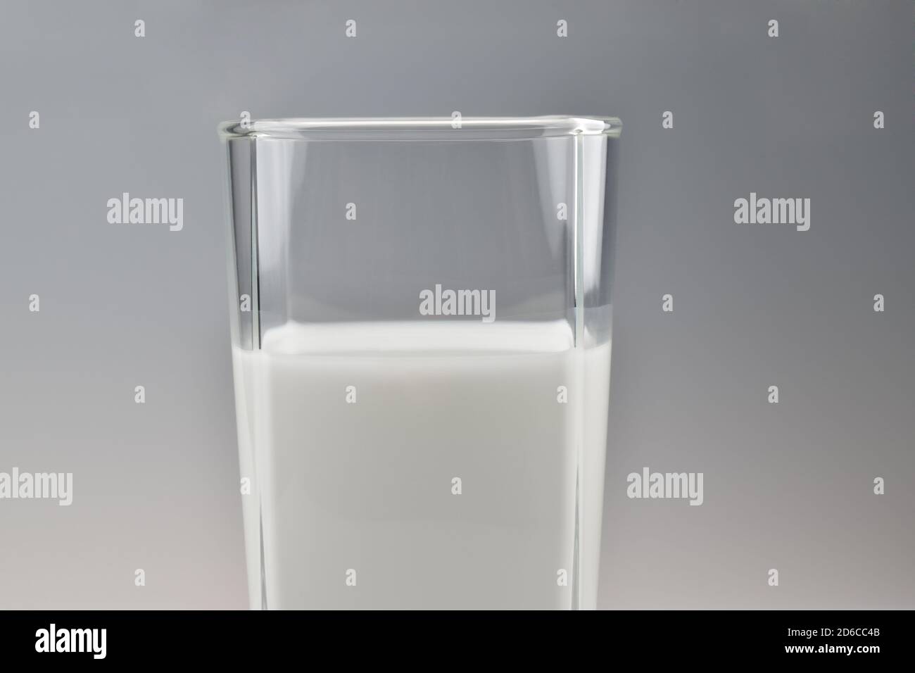 Glass of milk on grey gradient background, close-up photo Stock Photo ...