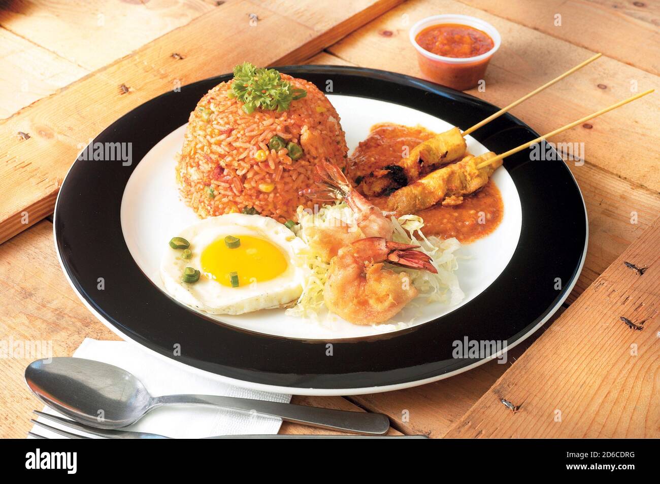 Asian cuisine fried rice with satay, fried shrimp and fried egg Stock ...