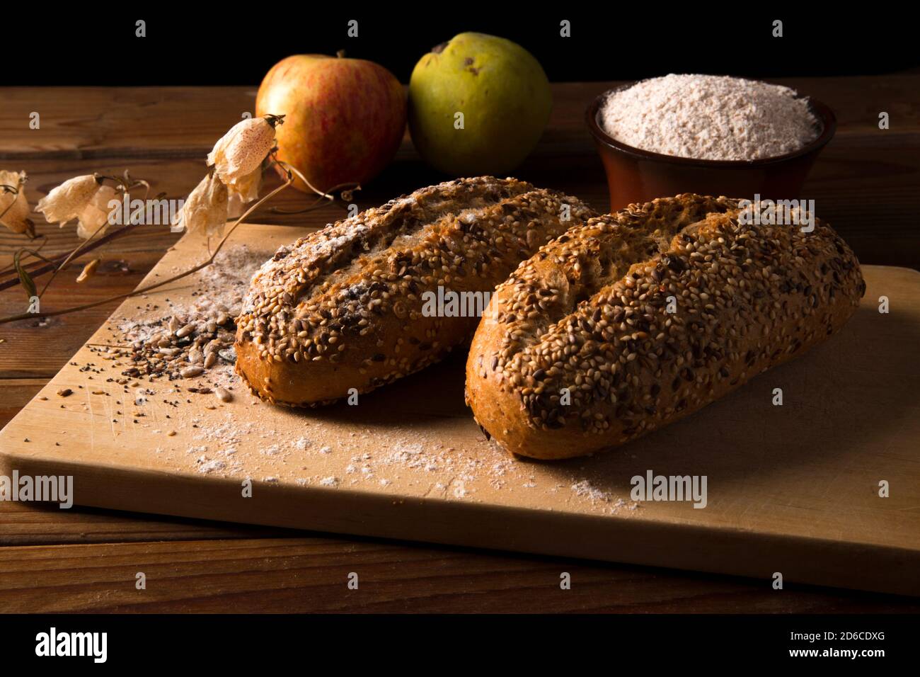 multigrain wholemeal bread with seeds on brown wooden table Stock Photo ...