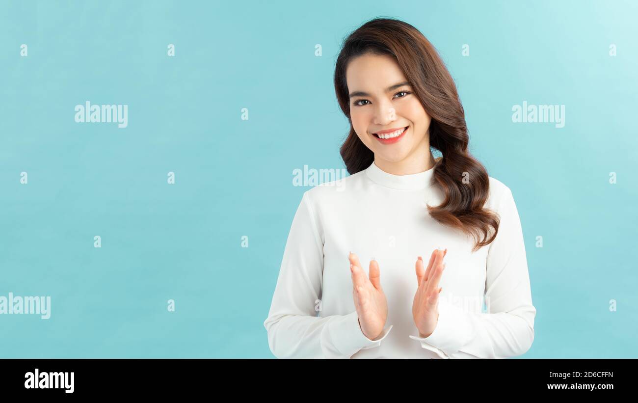 young pretty woman feeling happy and successful, smiling and clapping ...