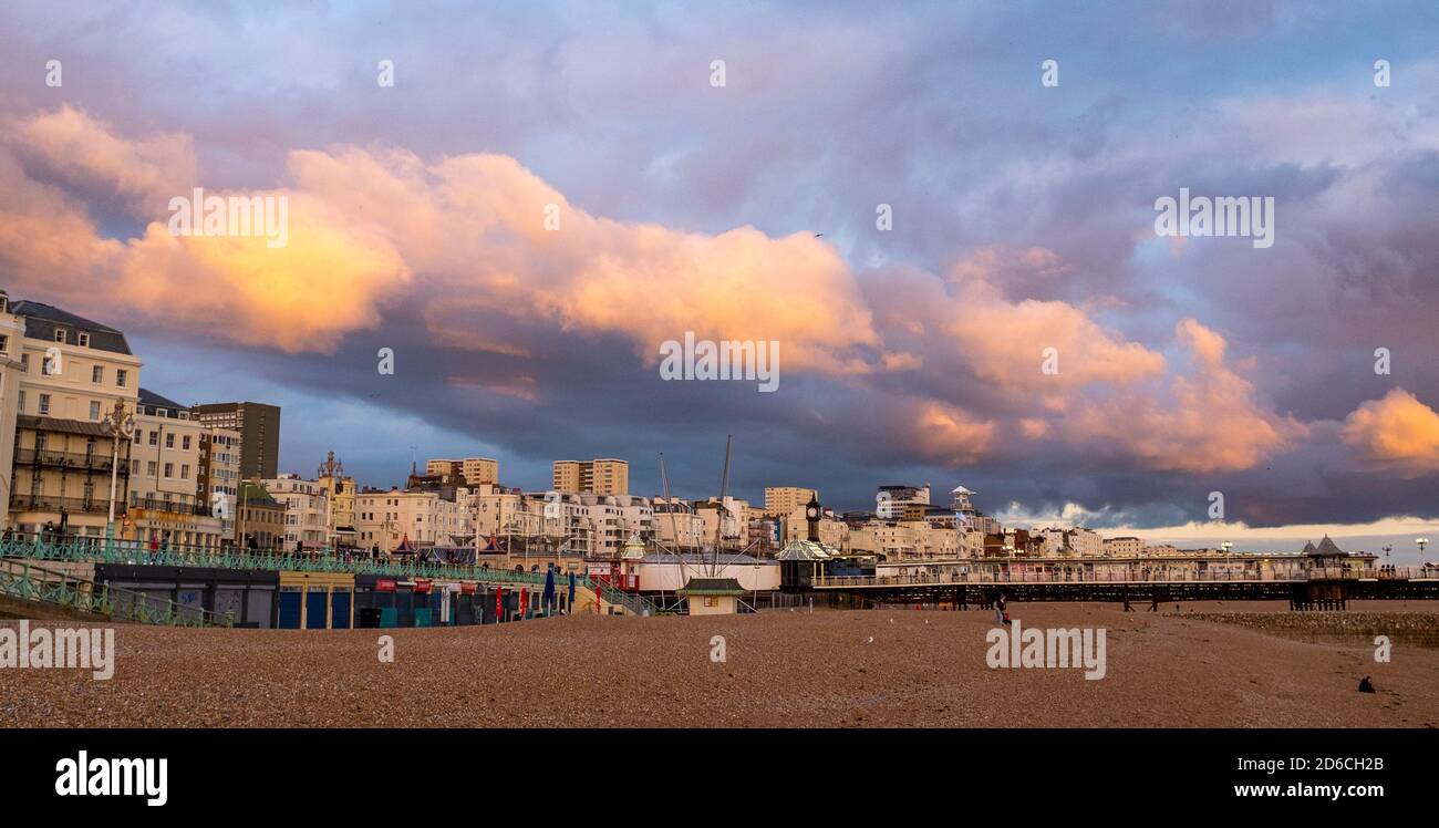 People on Brighton beach and seafront at sunset dusk Sussex England UK ...