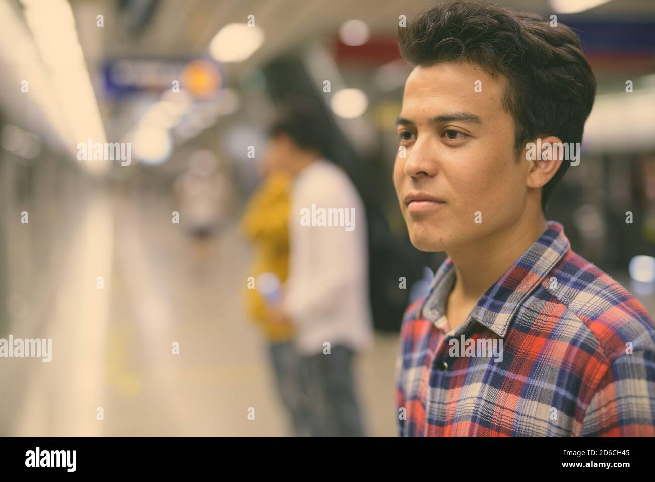 Three young Asian men inside the subway train station Stock Photo - Alamy